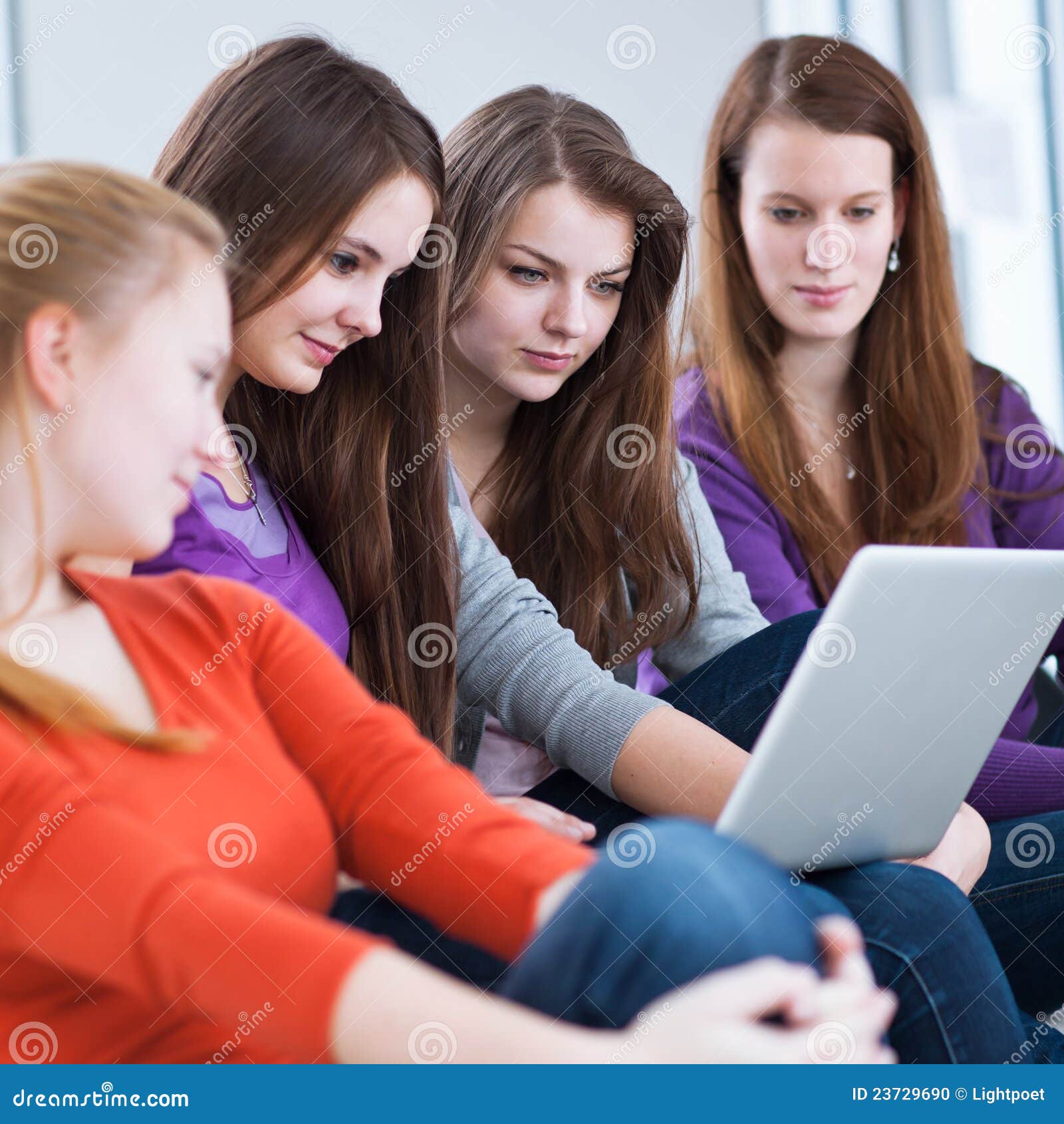 Four Female College Students Using a Laptop Stock Photo - Image of girl ...