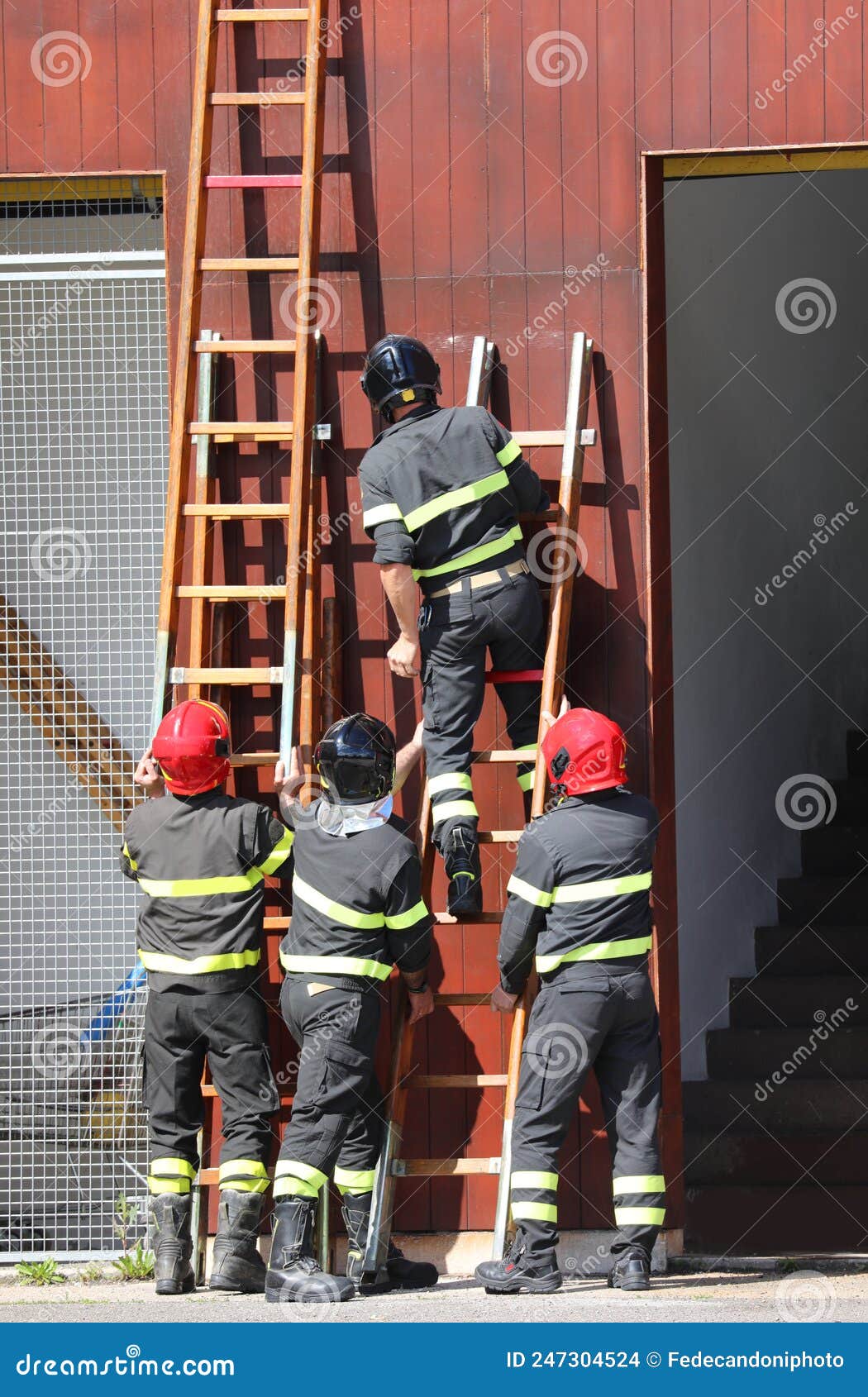 Four Firefighters in Action during the Exercise in the Fire Stat Stock ...