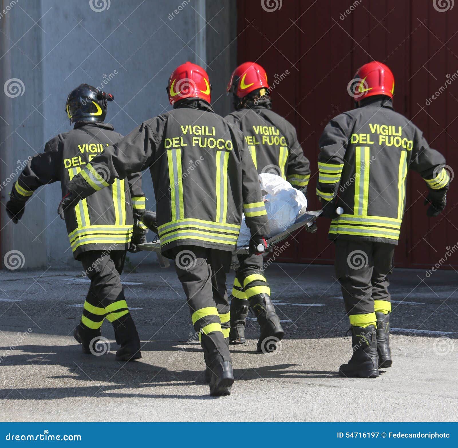 Four Firemen in Action Carry a Stretcher with Injured Stock Image ...