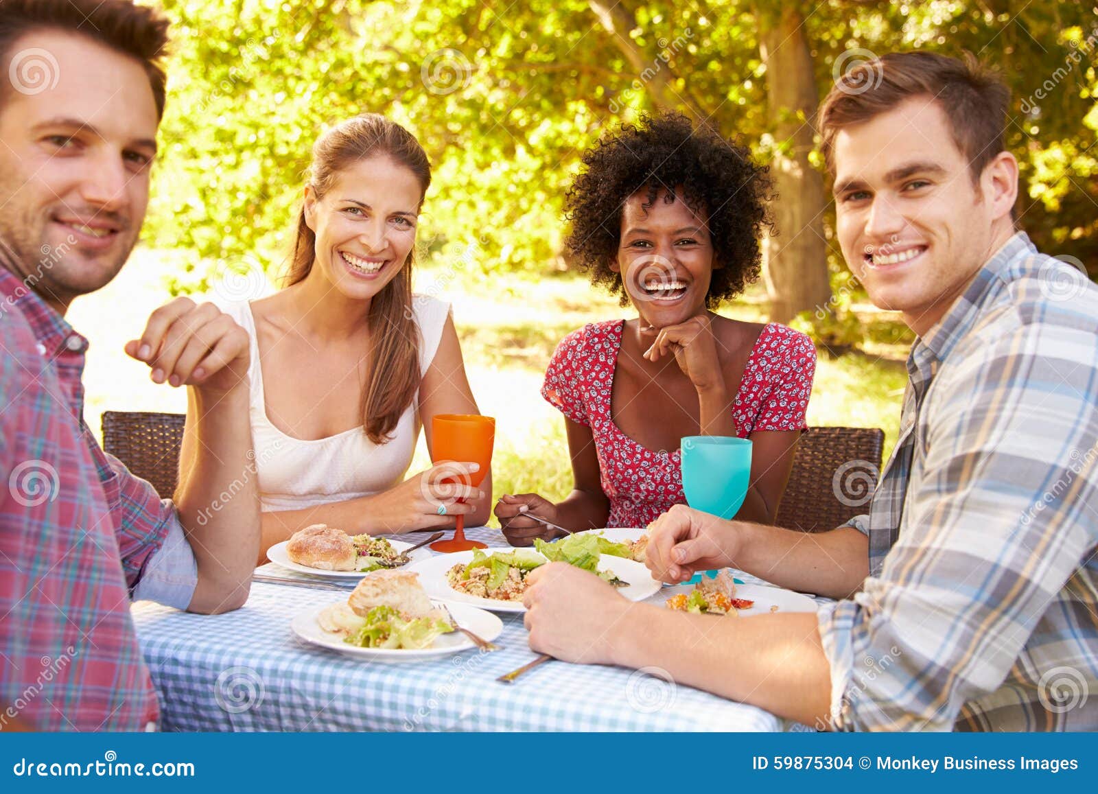 Four Friends Eating Together Outdoors Stock Photo - Image of dining ...