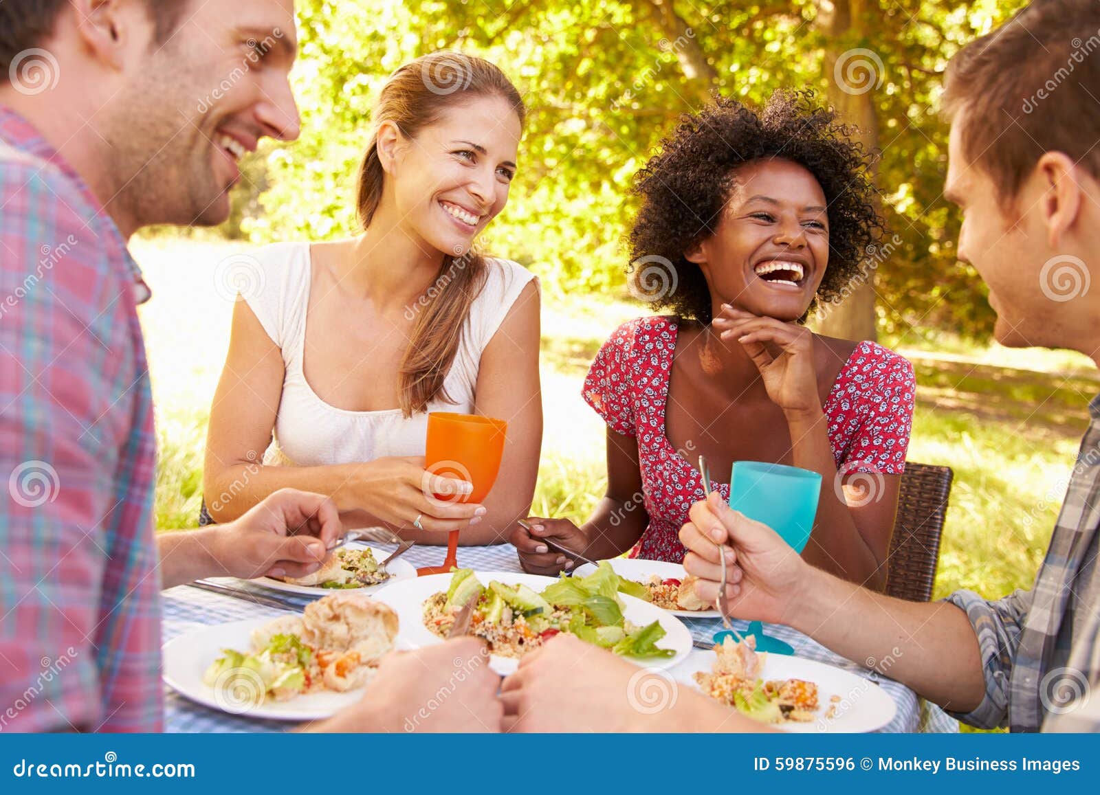 Four Friends Eating Together Outdoors Stock Photo - Image of happy ...