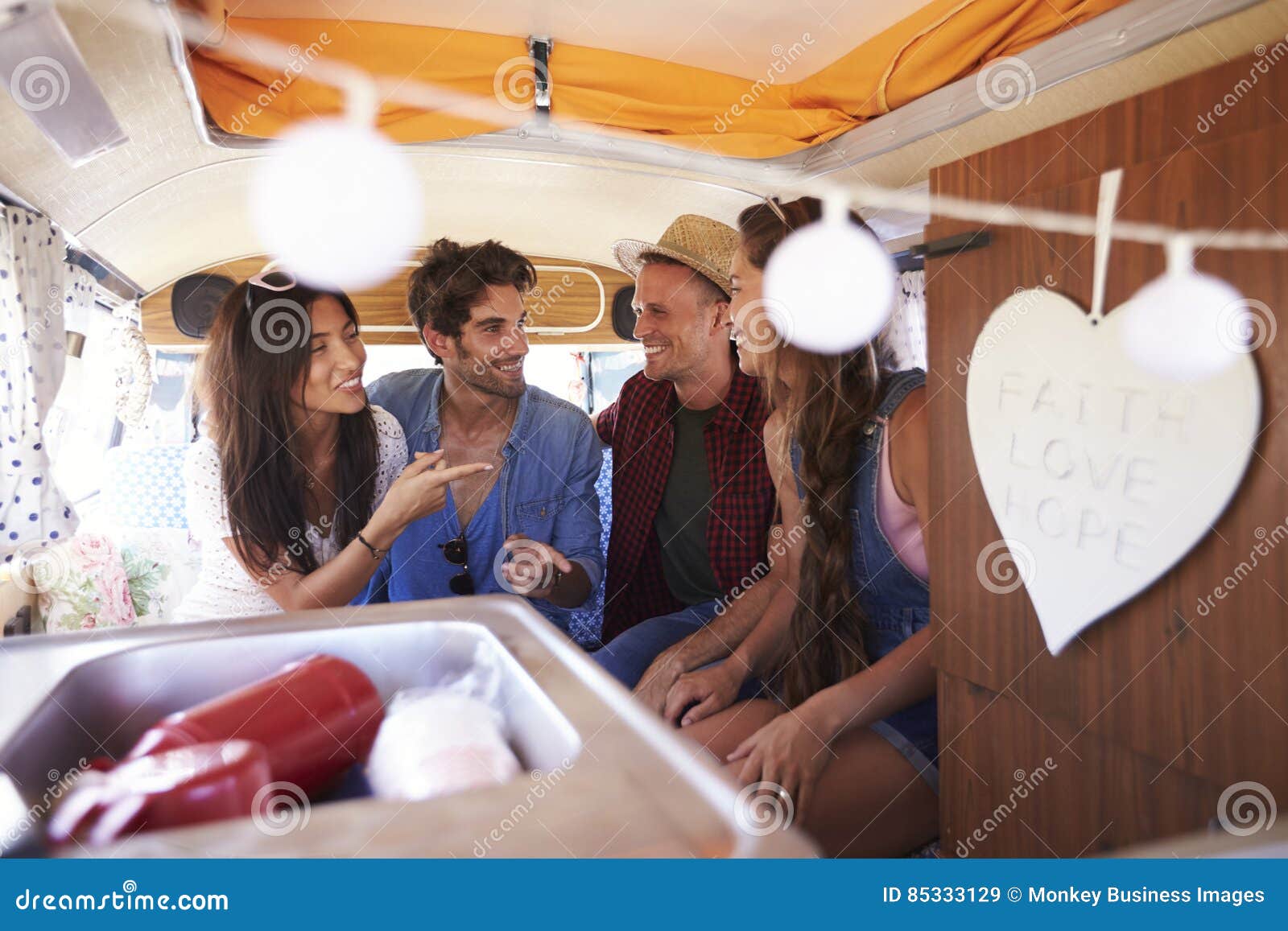 Four Friends on a Road Trip Talk in the Back of a Camper Van Stock ...