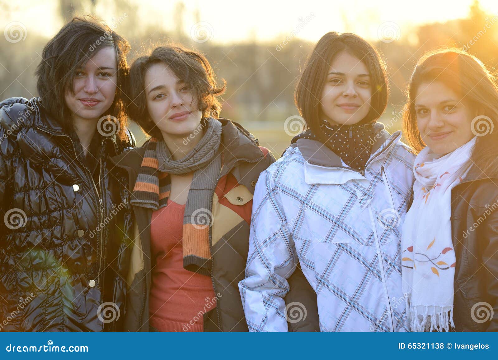 Four Friends Standing Together during Sunset Stock Photo - Image of ...