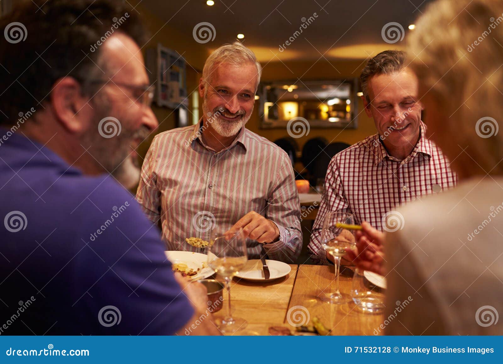 Four Friends Talking Together during a Meal at a Restaurant Stock Photo ...