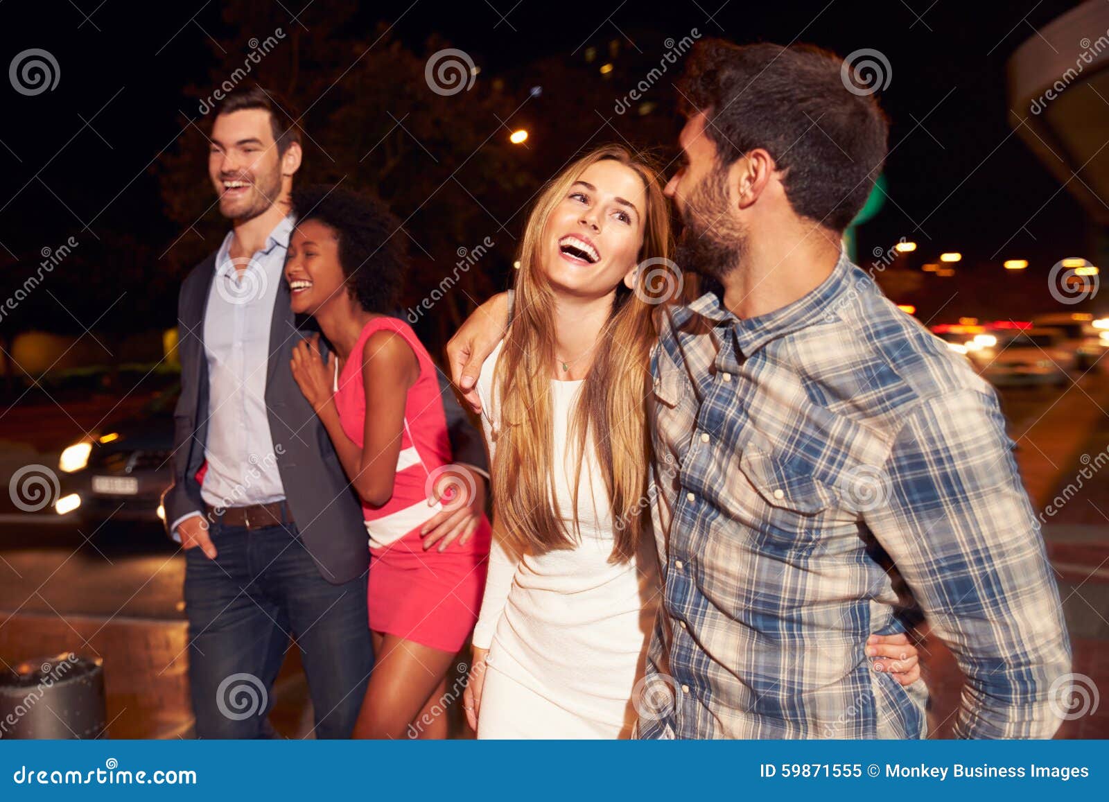 Four Friends Walking through Town Together at Night Stock Image - Image ...
