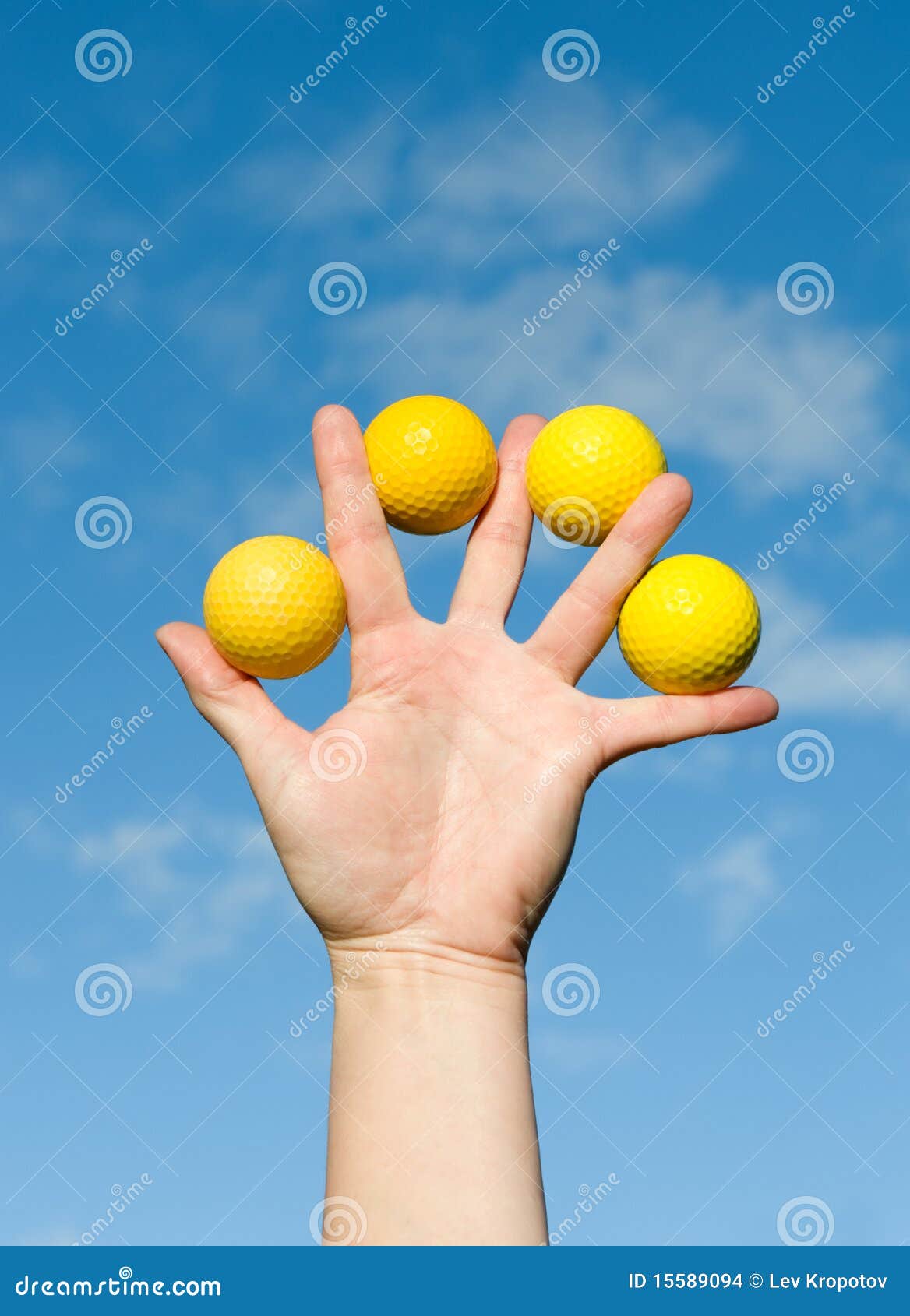 Four golf balls stock photo. Image of hand, green, yellow - 15589094
