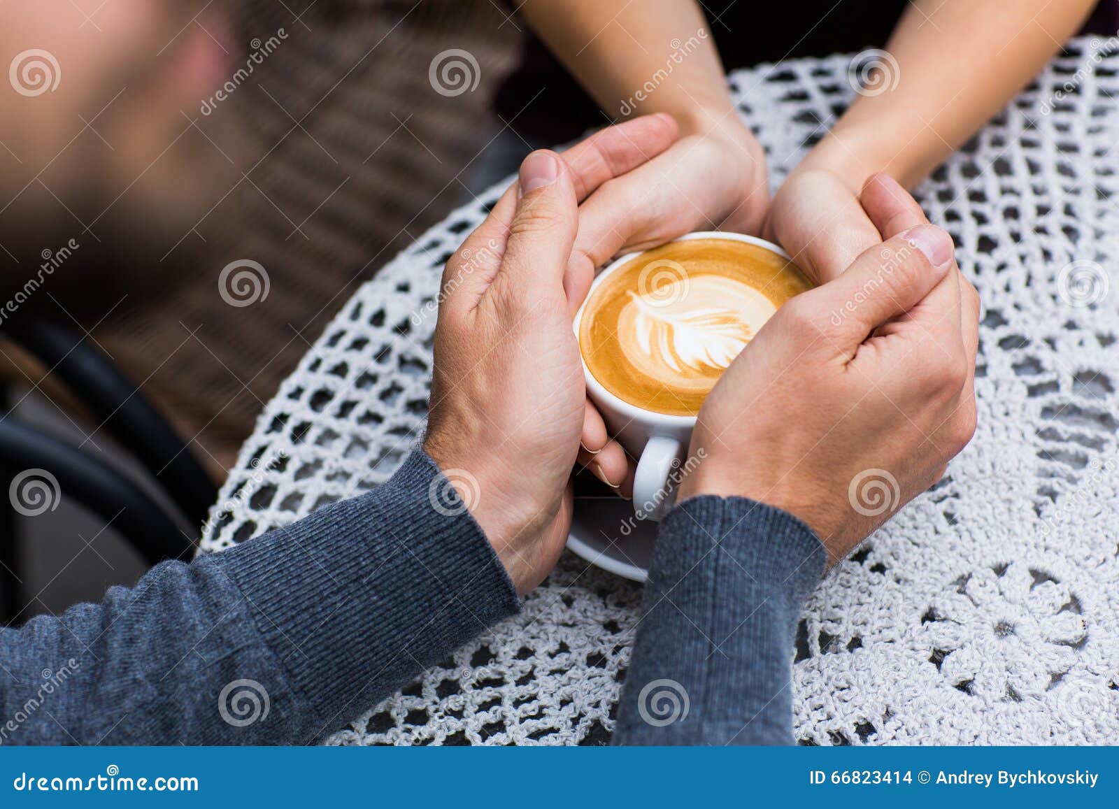 Four Hands Wrapped Around a Cup of Coffee Stock Photo - Image of ...