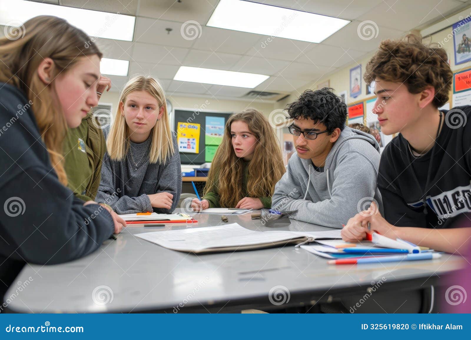 Four High School Students Work Together on a Group Project in a ...