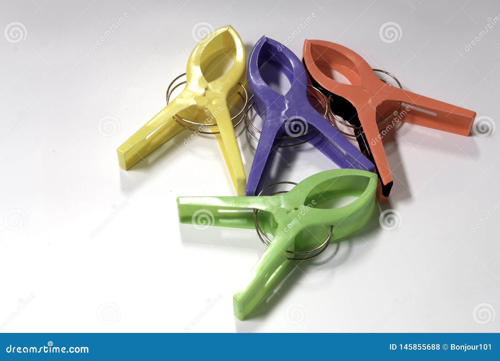 Four Large Cloth Clamps in Various Colors on a White Background. Stock ...