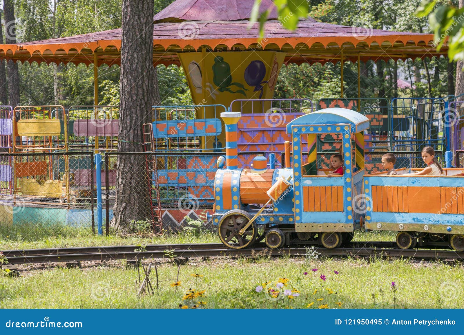 Four Little Children are Riding on a Children& X27;s Train in the Park ...