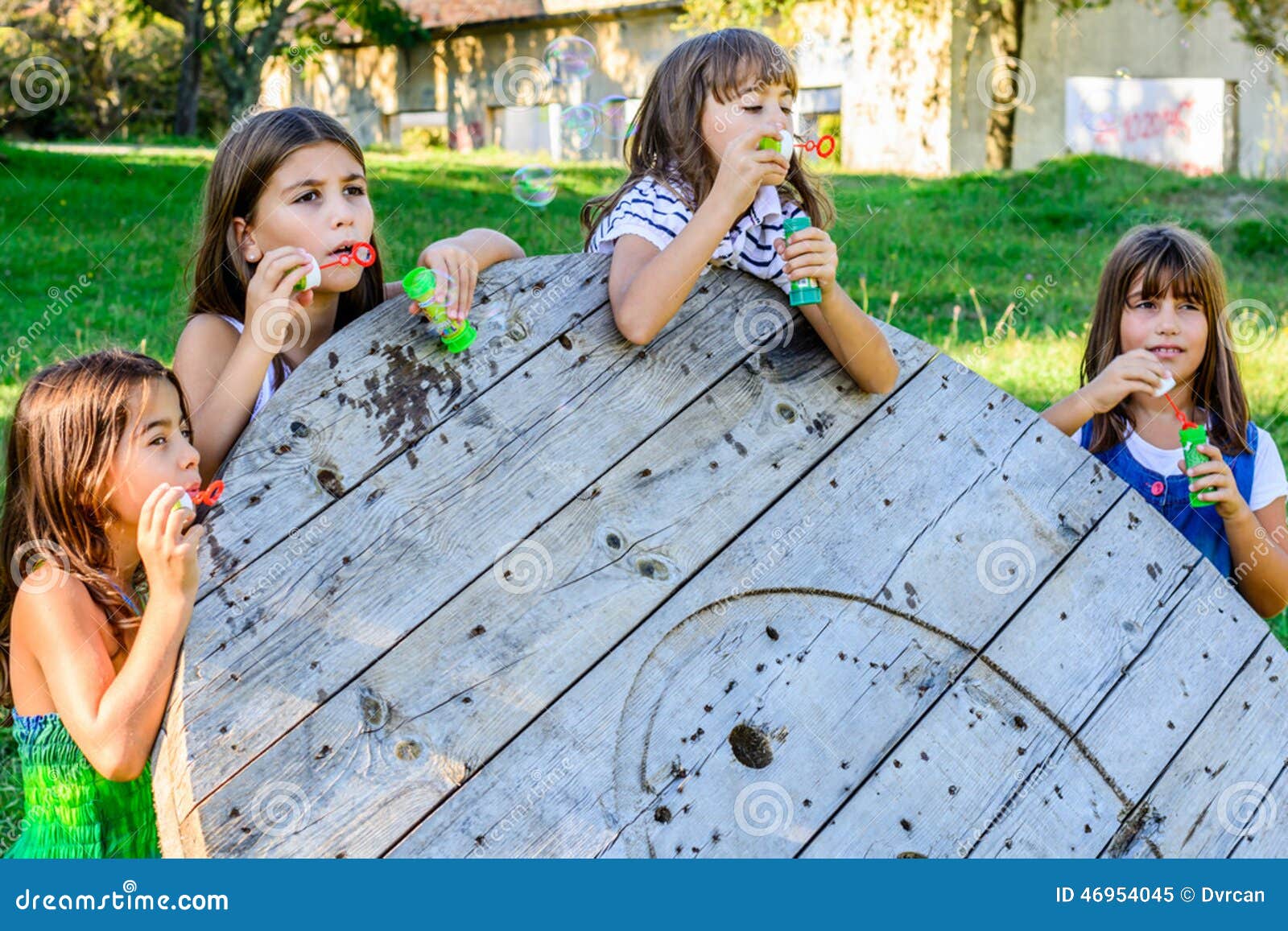 Four Little Girls Blowing Bubbles in the Park Stock Image - Image of ...