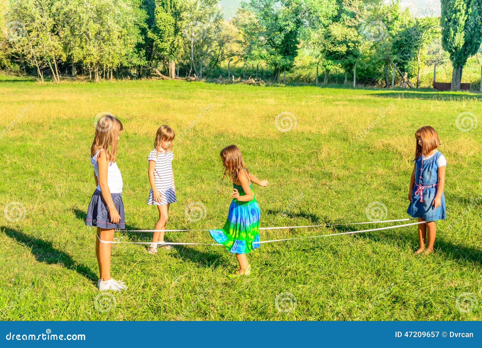 Four Little Girls Playing Elastics in the Park Stock Image - Image of ...