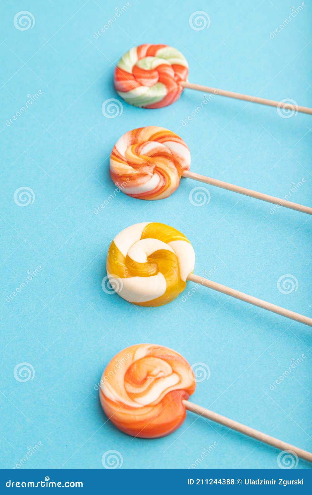 Four Lollipop Candies on Blue Background. Copy Space, Side View Stock ...