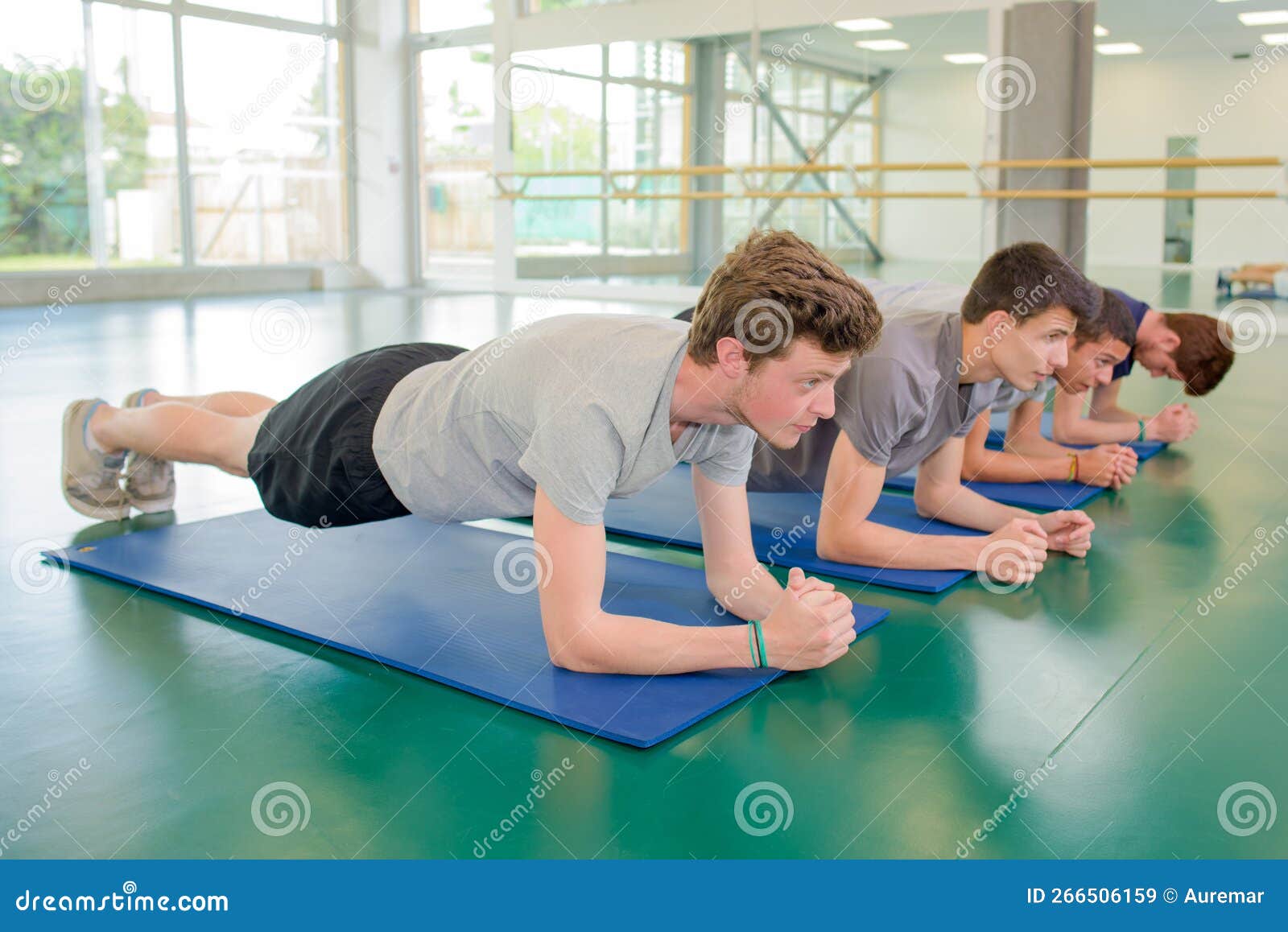 Four Men Exercising in Plank Position Stock Image - Image of team ...