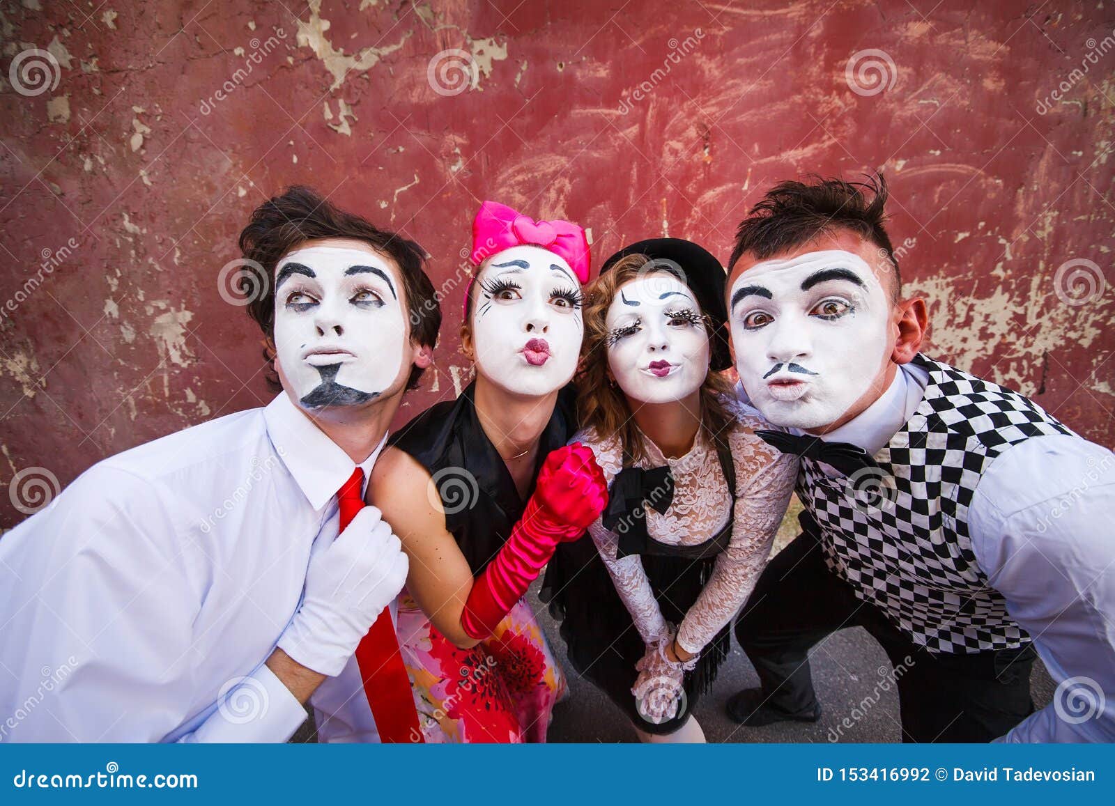 Four Mimes Cute Pose in Front of a Red Wall Stock Photo - Image of ...
