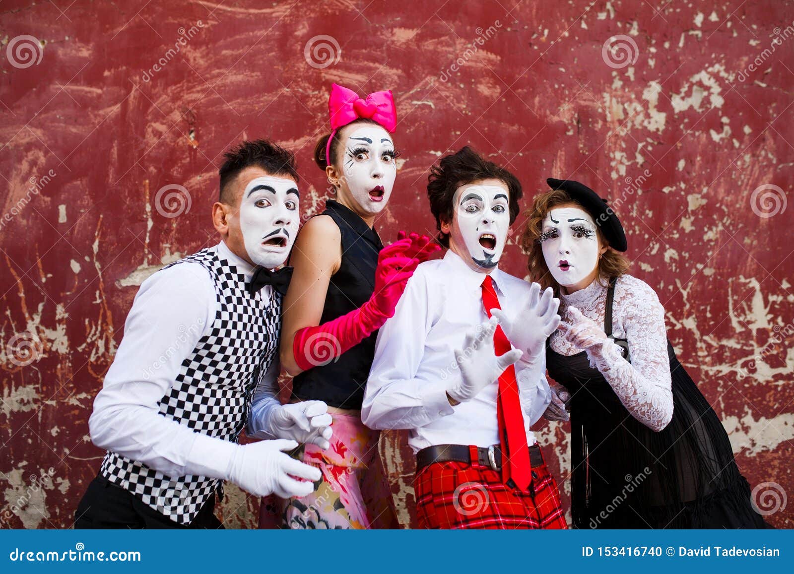 Four Mimes in Fear Stand in the Background of a Red Wall. Stock Photo ...