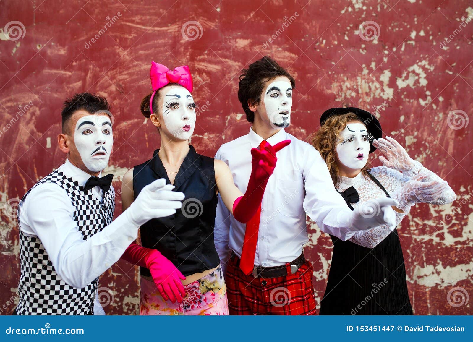 Four Mimes Looking Aside on the Background of a Red Wall Stock Image ...