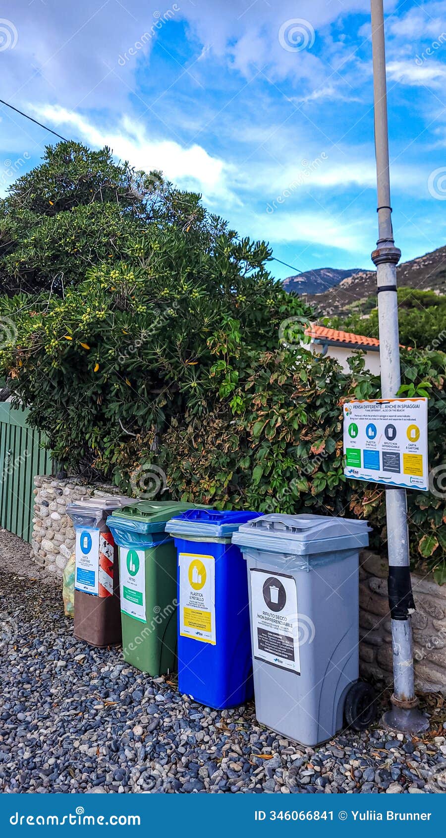 Four Multicolored Garbage Sorting Containers in the Beach Against the ...