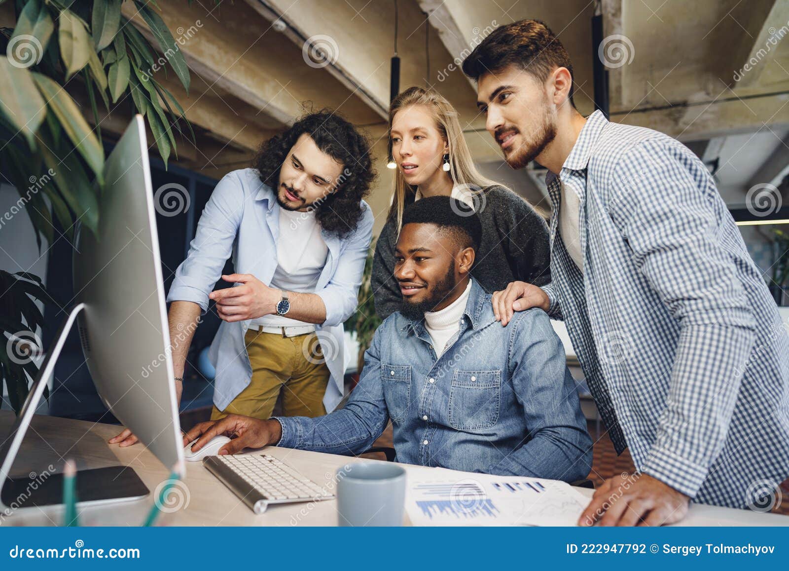 Four Multiethnic Colleagues Looking at Computer Screen in Office Stock ...