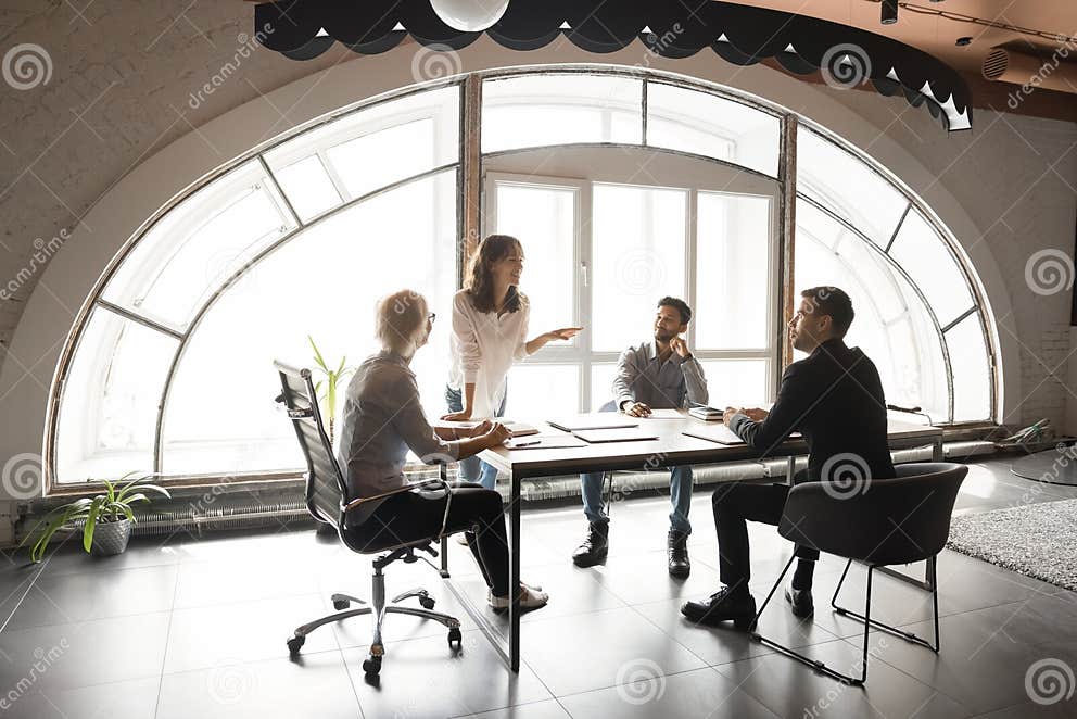 Four Multiethnic Teammates Solve Work-related Issues in Boardroom Stock ...