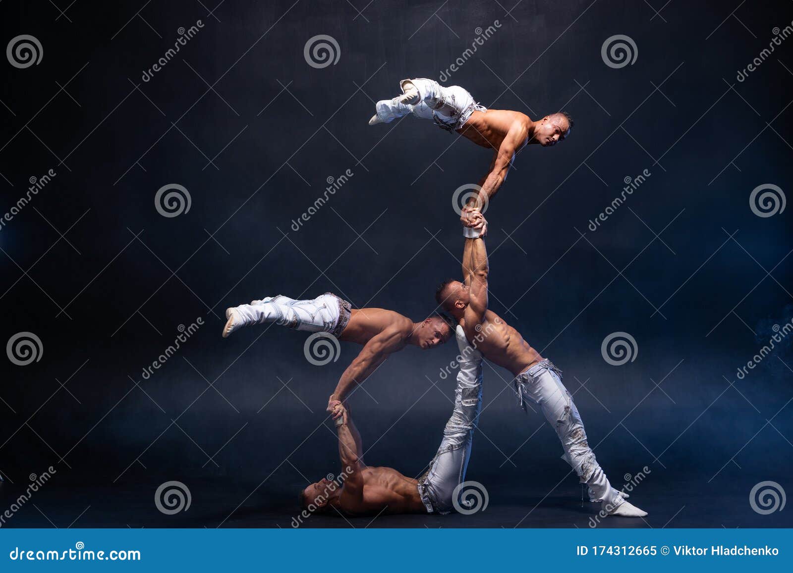 Four Muscular Man Perform Difficult Acrobatic Tricks on Black Studio ...