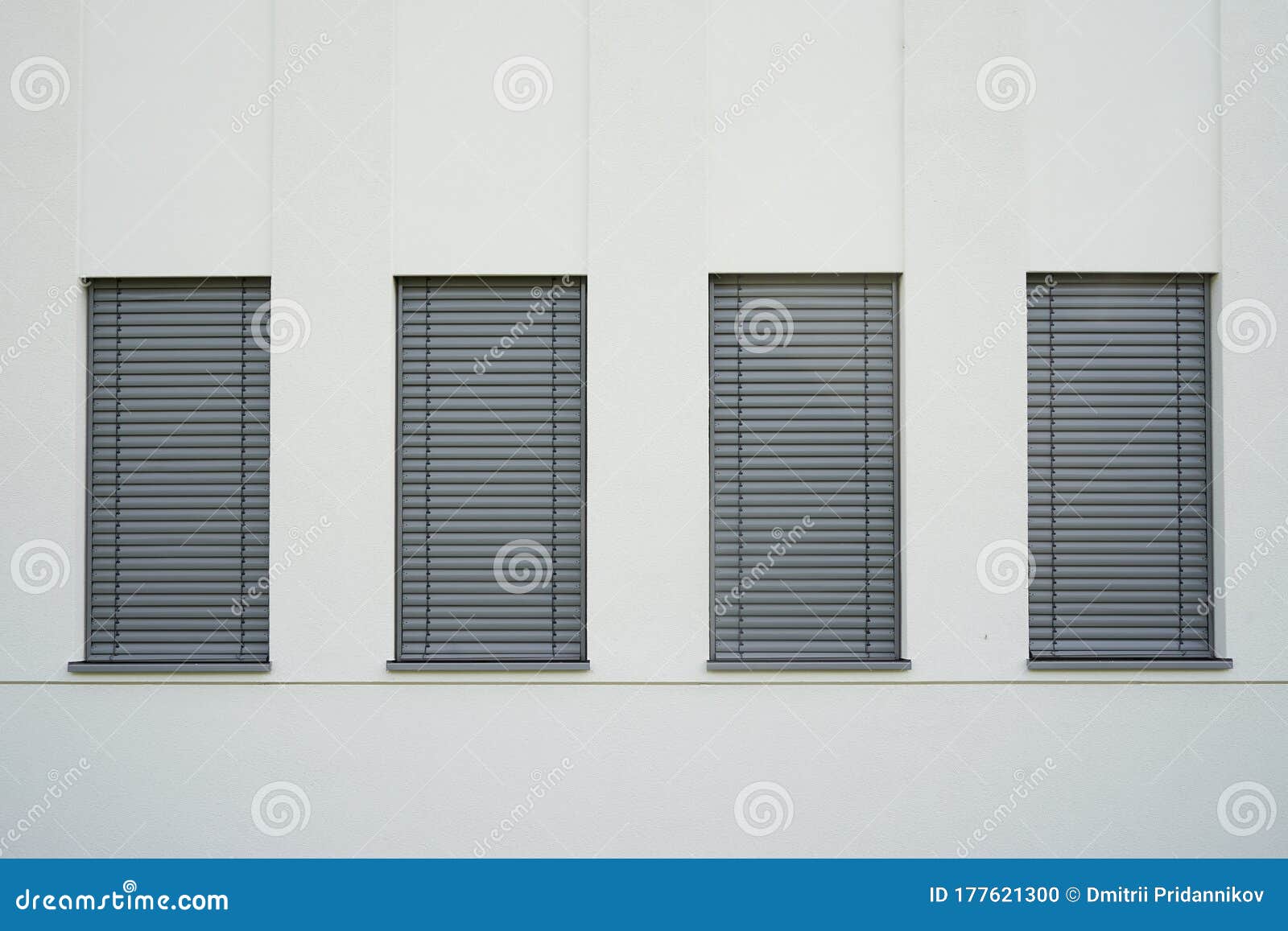 Four Narrow Windows with Closed Gray Role Shutters on the Light Wall ...