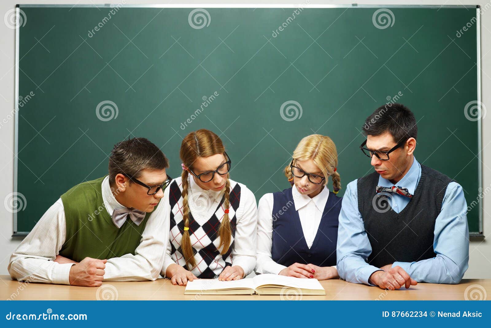 Four nerds reading book stock photo. Image of green, education - 87662234