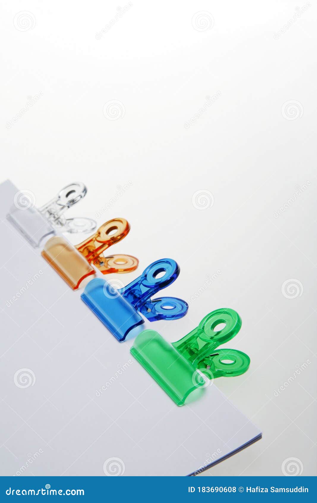 Four Paper Clips Clipping the Same Stack of Papers Stock Photo - Image ...