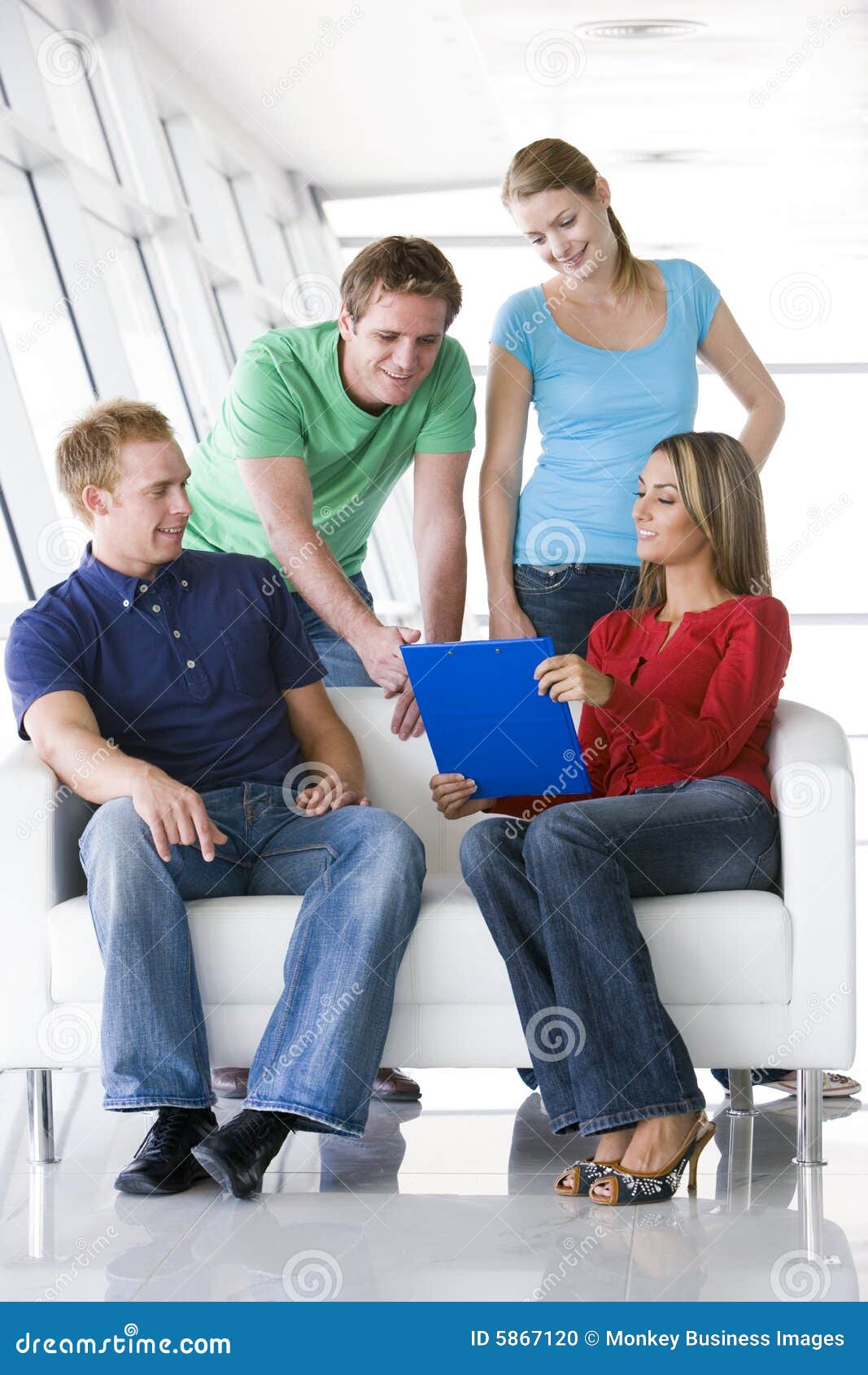 Four People Having Fun And Smiling Together At Home Holding Up The Four ...