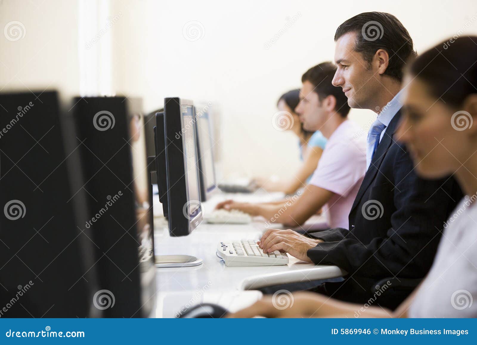 Four People Sitting In Computer Room Typing Stock Photography ...