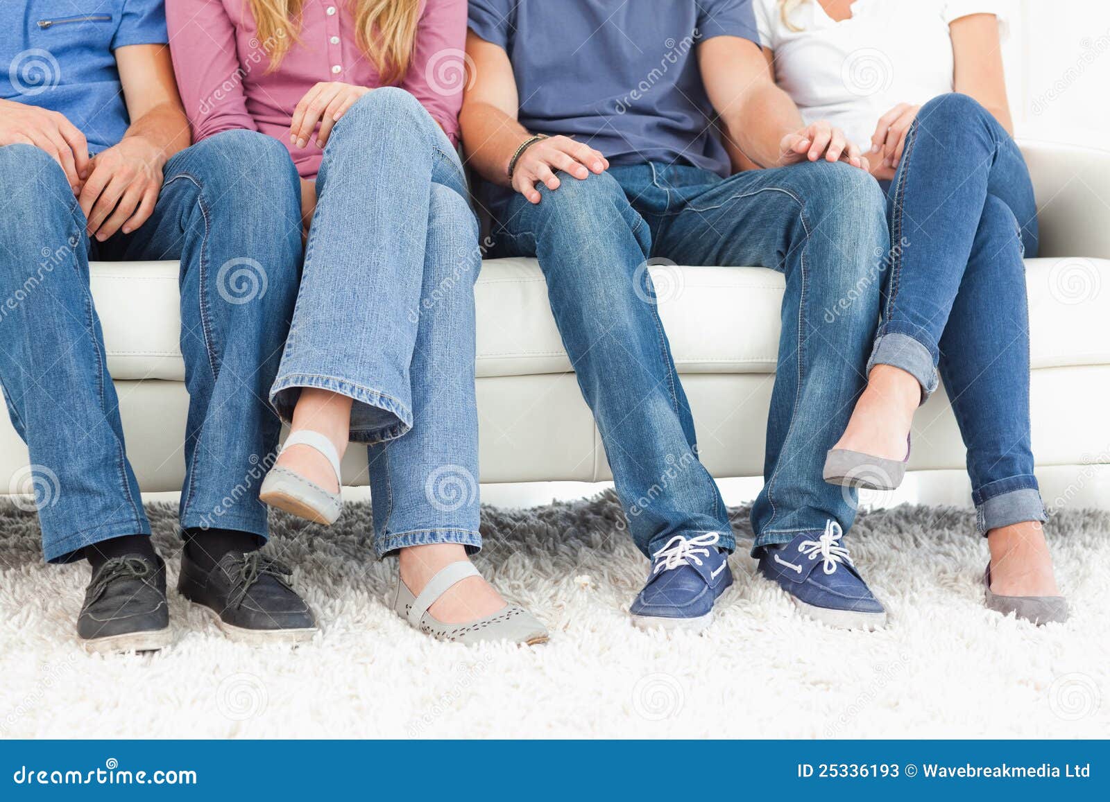 Four People Sitting on the Couch Stock Image - Image of hands, living ...