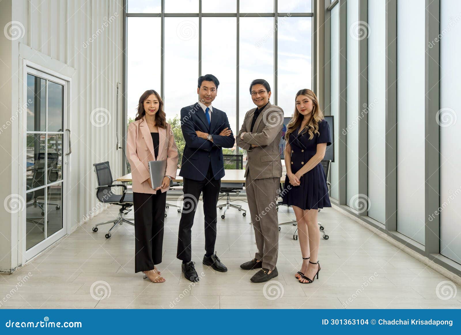 Four People Stand Together in a Bright Office with Big Windows on a ...