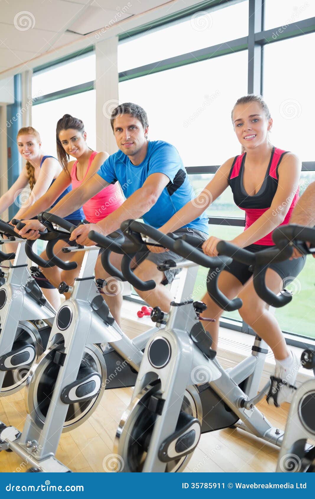Four People Working Out at Spinning Class Stock Image - Image of ...