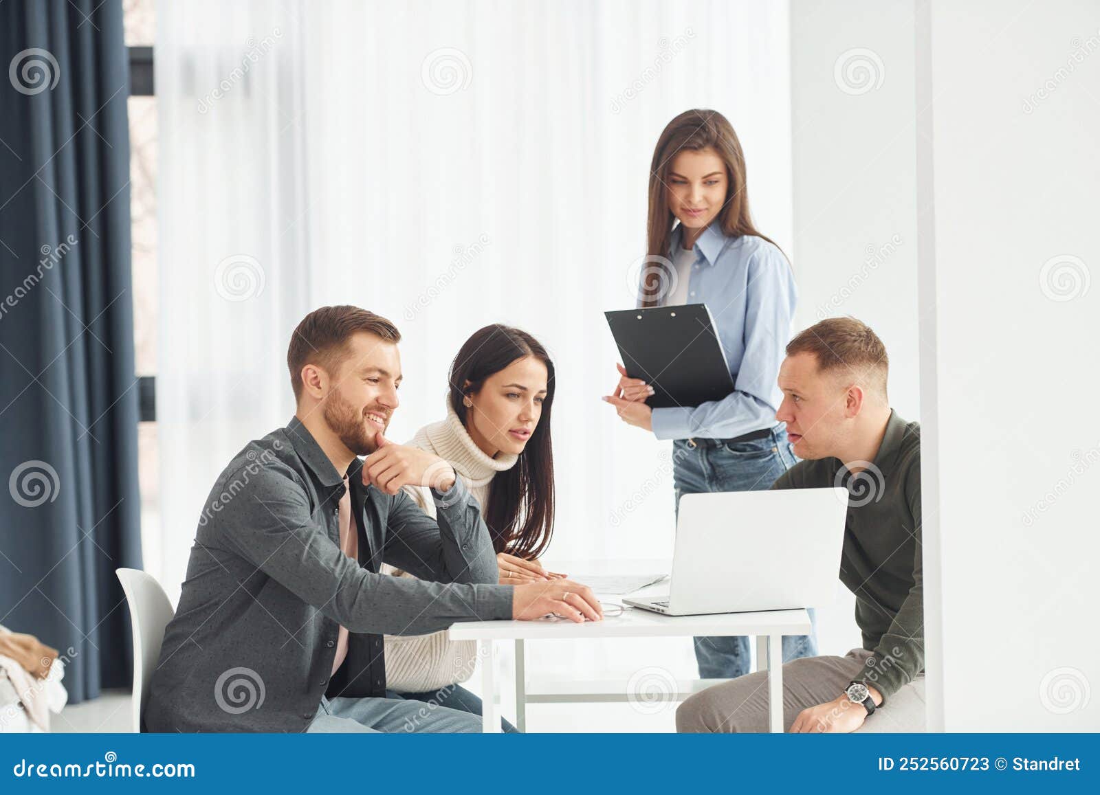 Four People Works in the Office by Sitting by the Table Indoors Stock ...