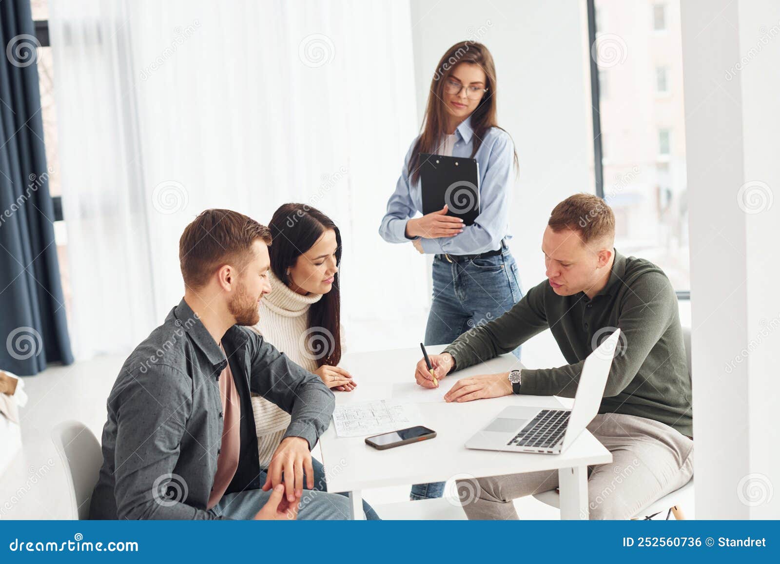 Four People Works in the Office by Sitting by the Table Indoors Stock ...