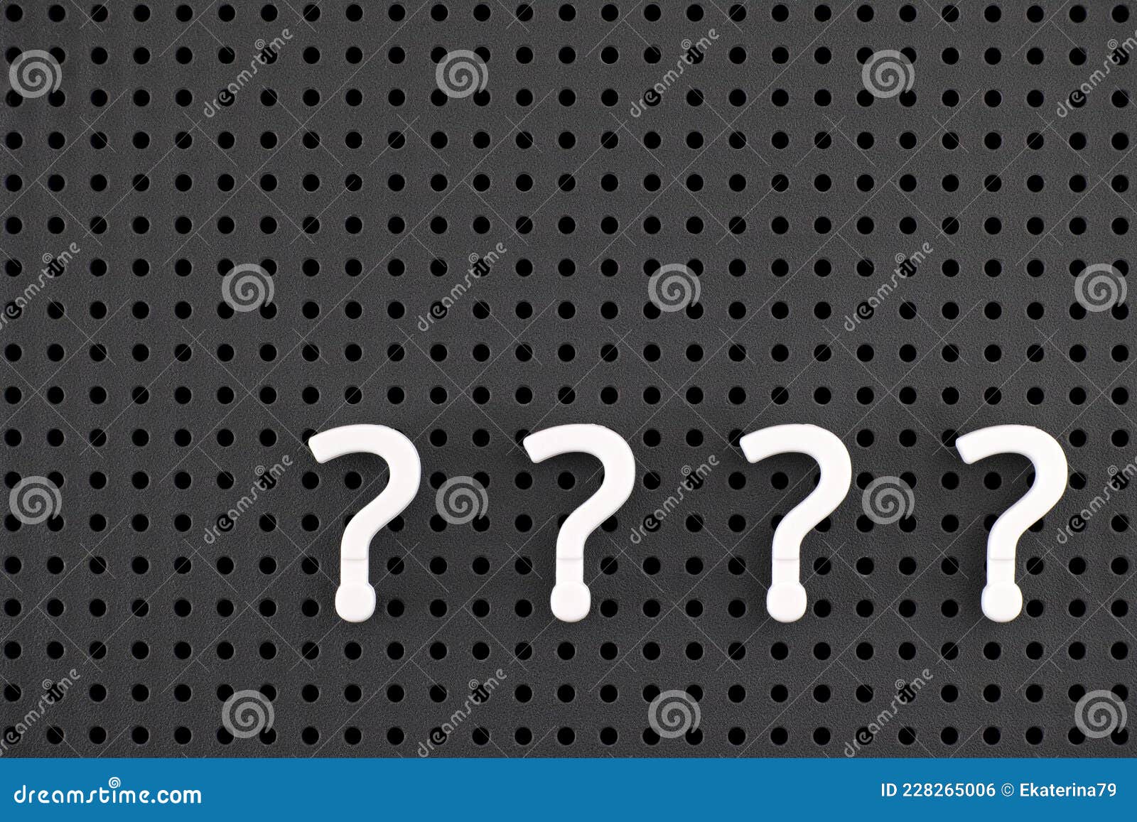 Four Question Marks Spelled Out by White Symbols on Gray Pegboard Stock ...