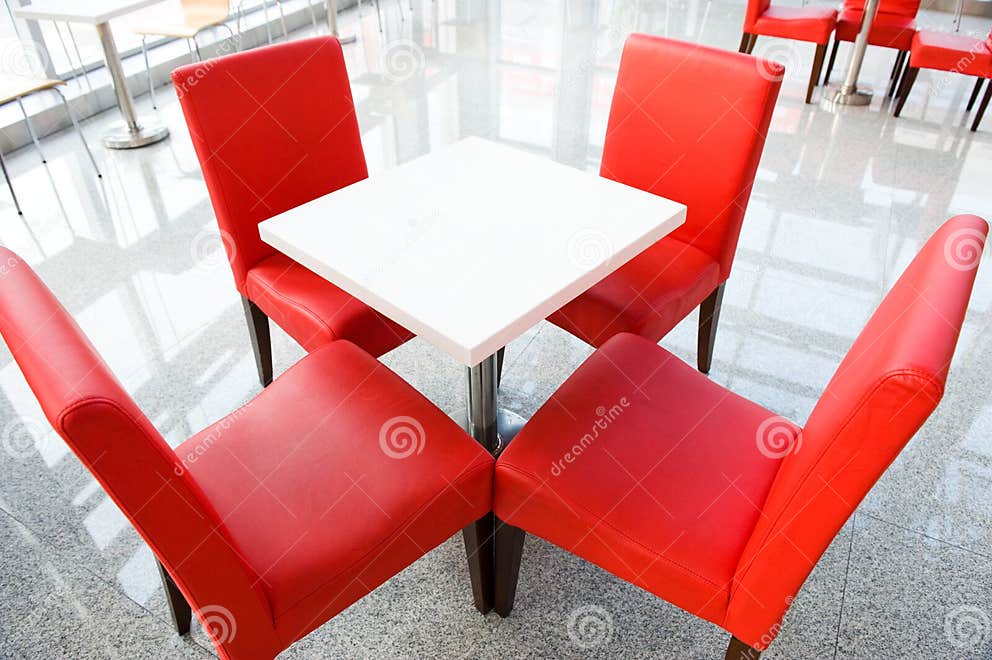 Four red chairs at a table stock image. Image of business - 15997227
