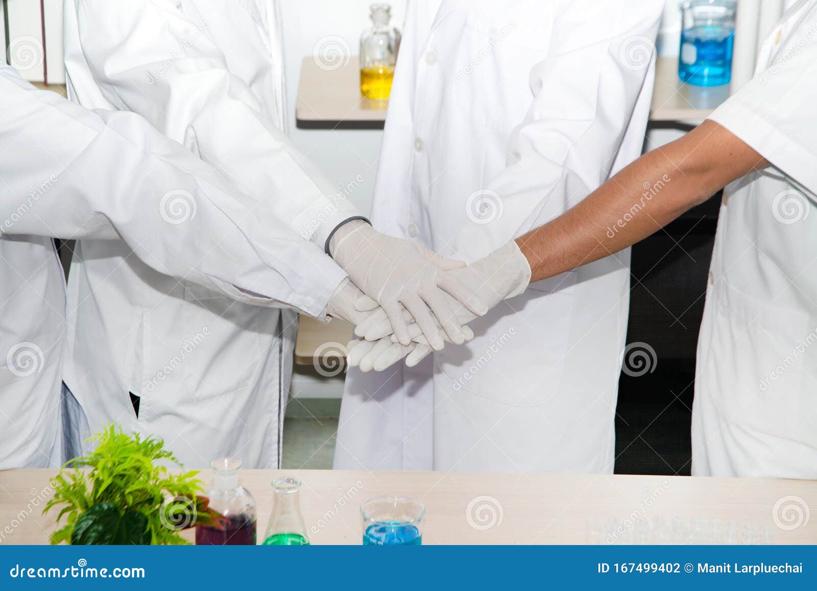 Four Scientists Standing in Hand To Show that the Experiment is ...