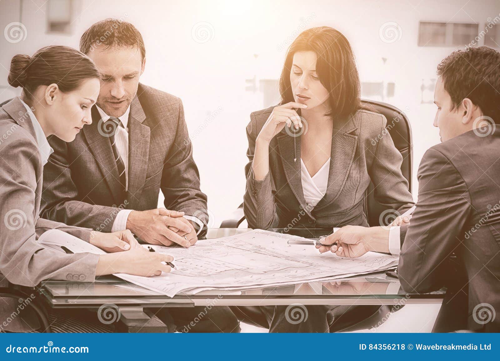 Four Serious Engineers Looking at Plans Sitting at a Table Stock Photo ...