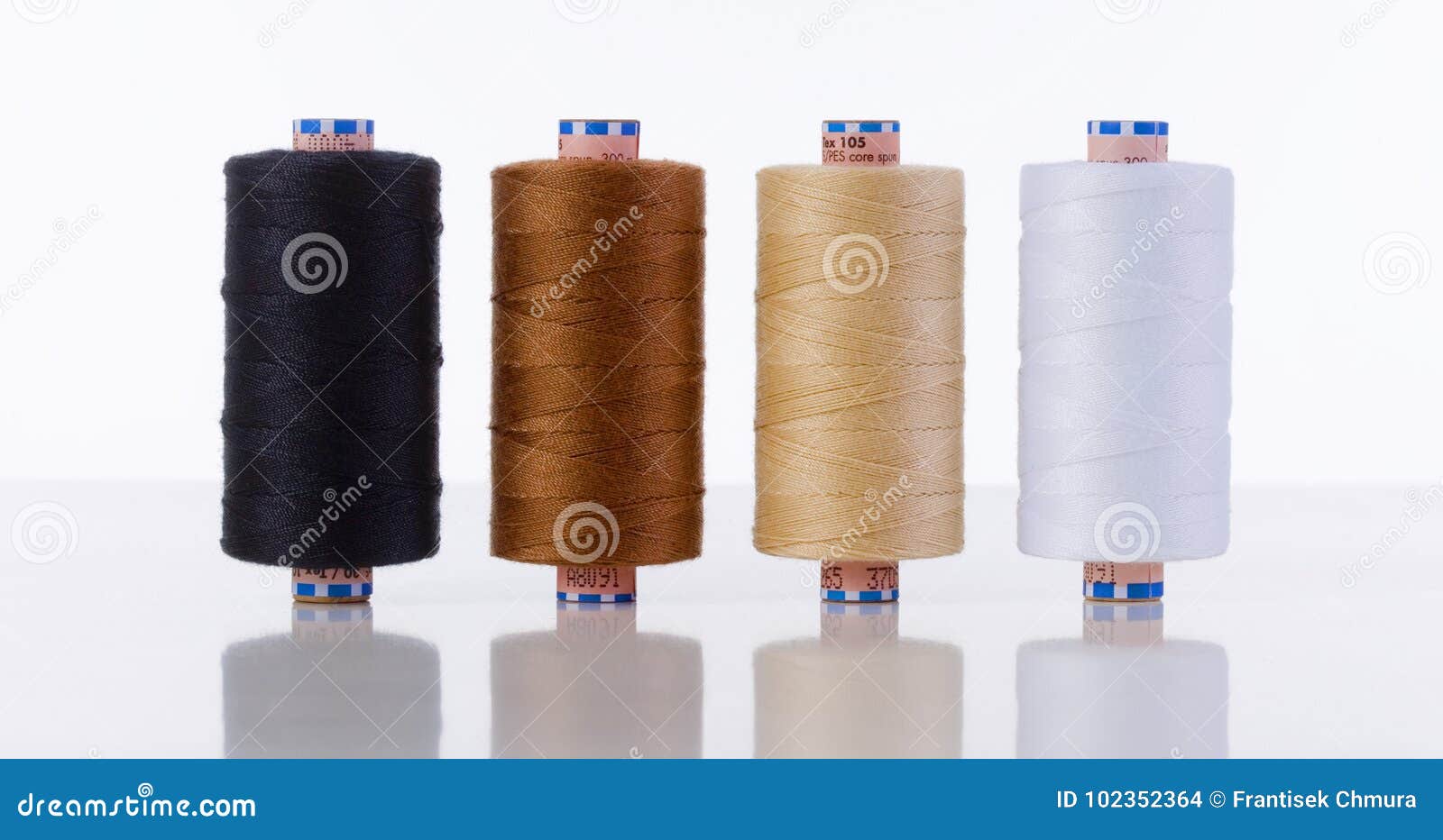 Four Sewing Thread Reels of Different Colors Stock Photo - Image of ...