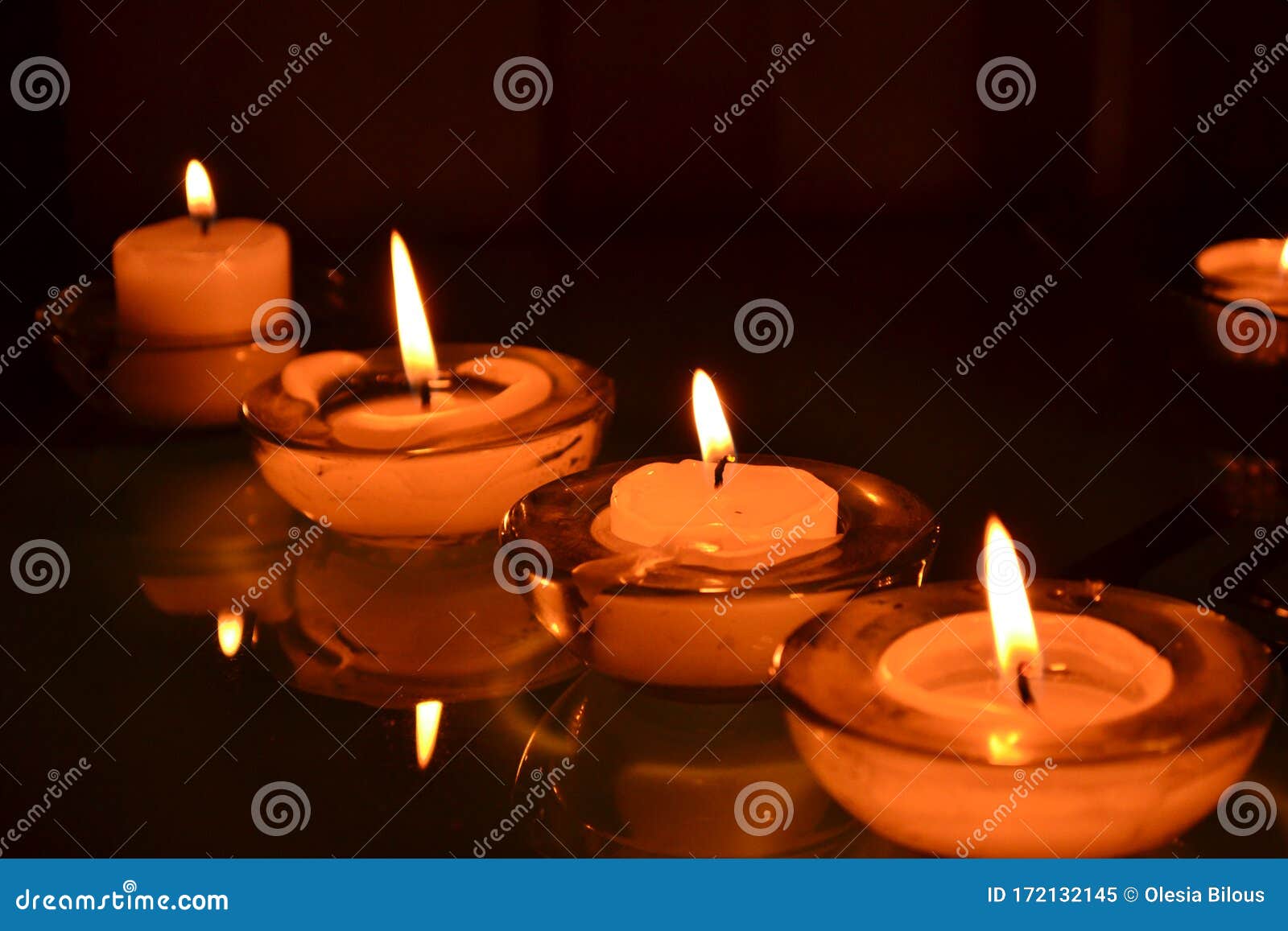 Four Small Candlesticks with Burning Even Flame Candles on a Smooth ...