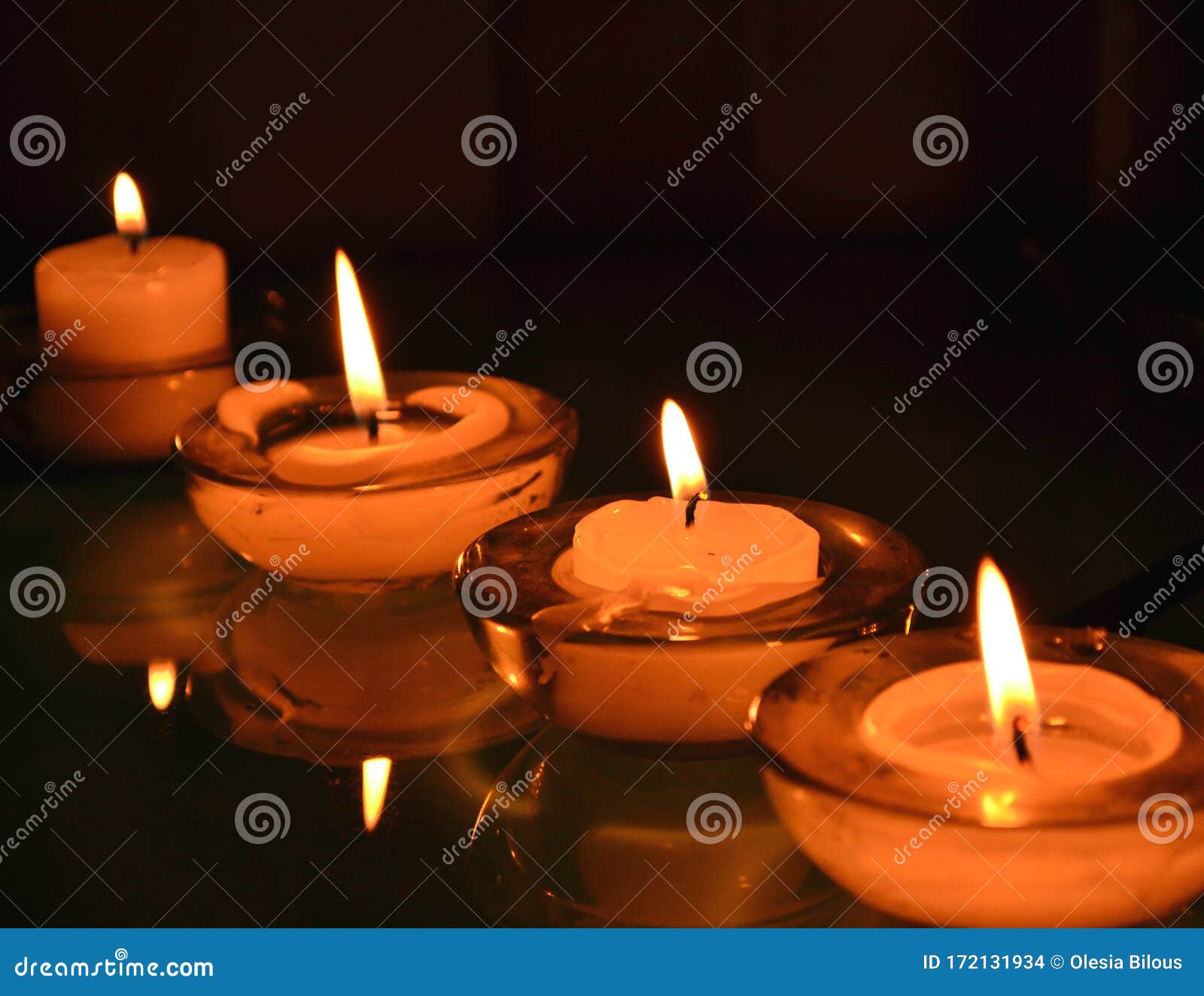 Four Small Candlesticks with Burning Even Flame Candles on a Smooth ...