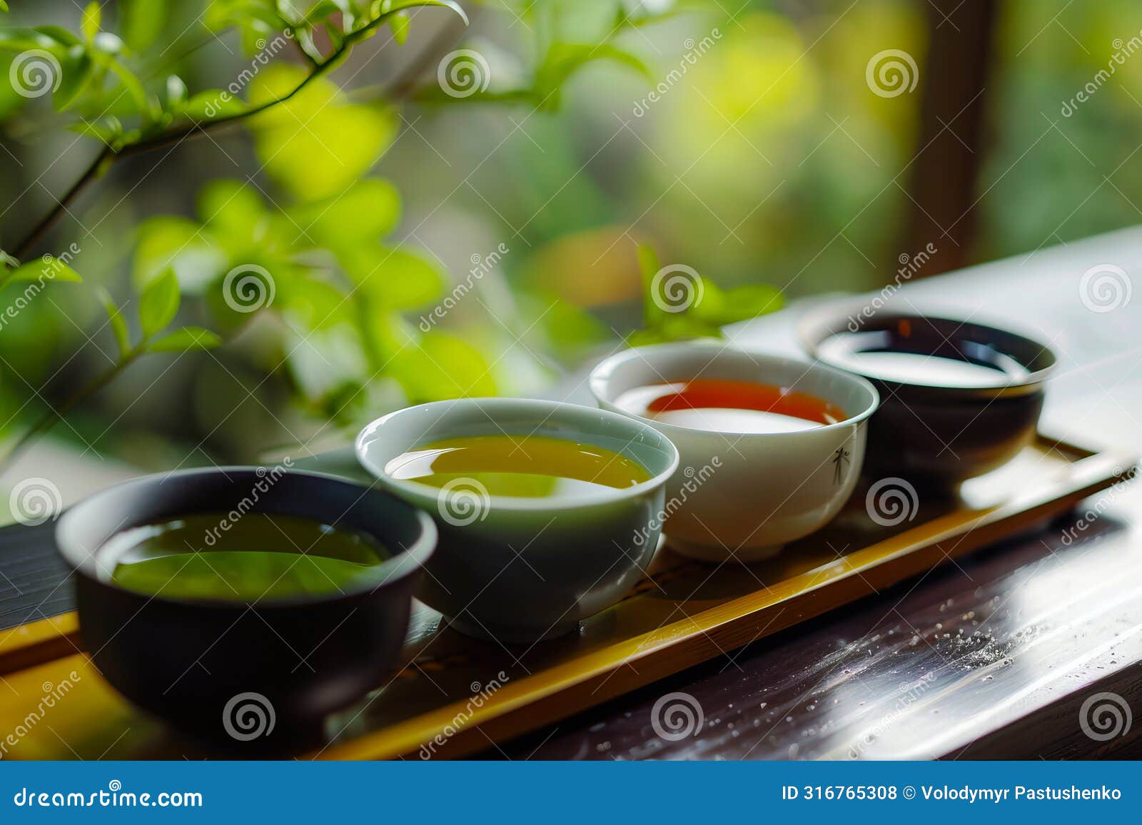 Four Small Cups of Tea on a Tray Stock Photo - Image of mixing, four ...