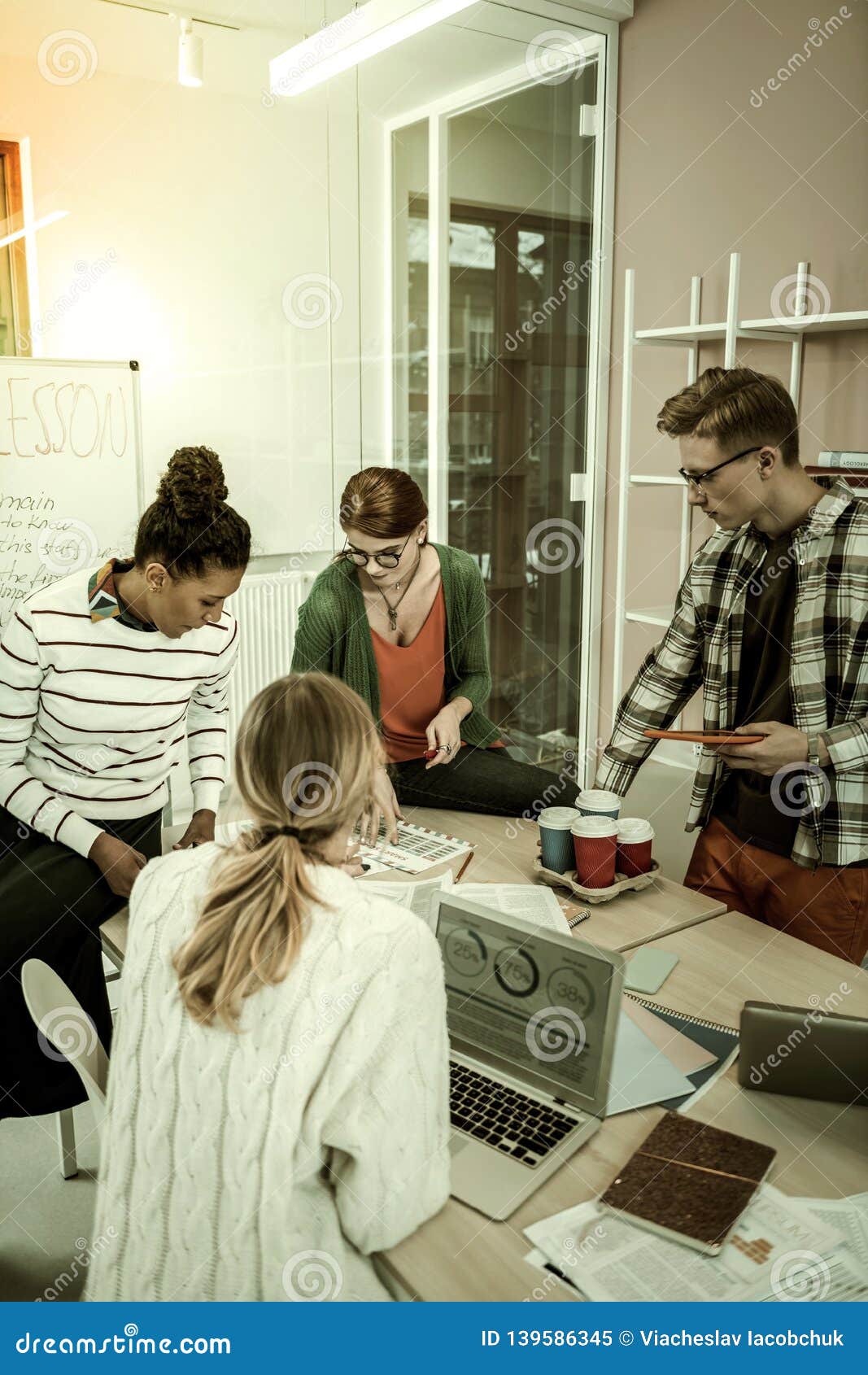 Four Smart Students Drinking Coffee and Studying Together Stock Image ...