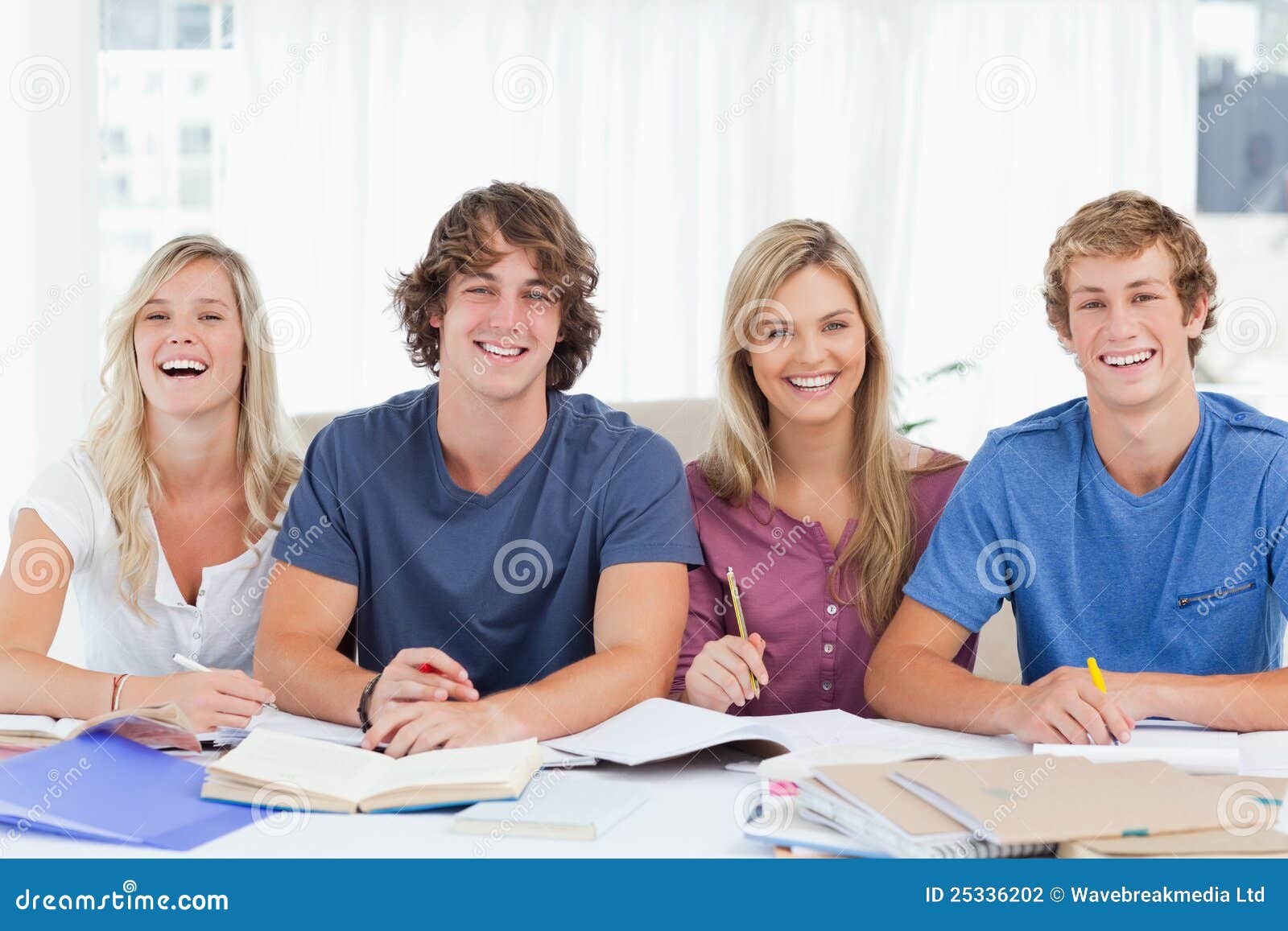 Four Smiling Students Looking into the Camera Stock Photo - Image of ...