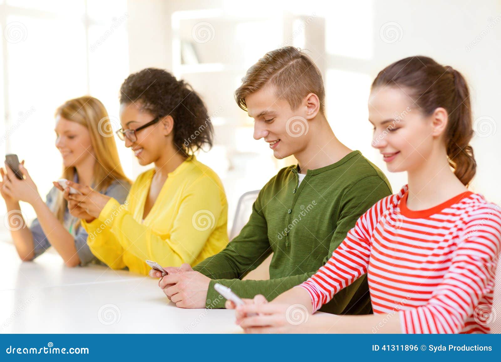 Four Smiling Students with Smartphones at School Stock Photo - Image of ...