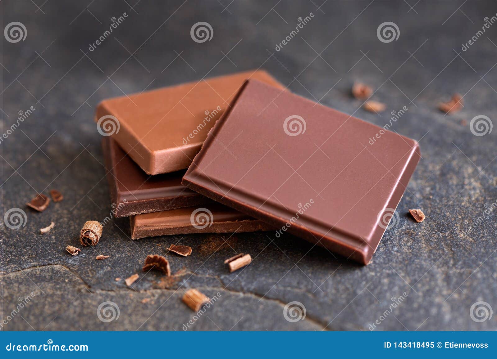 Four Squares of Dark and Milk Chocolate Isolated on Grey Slate. Small ...