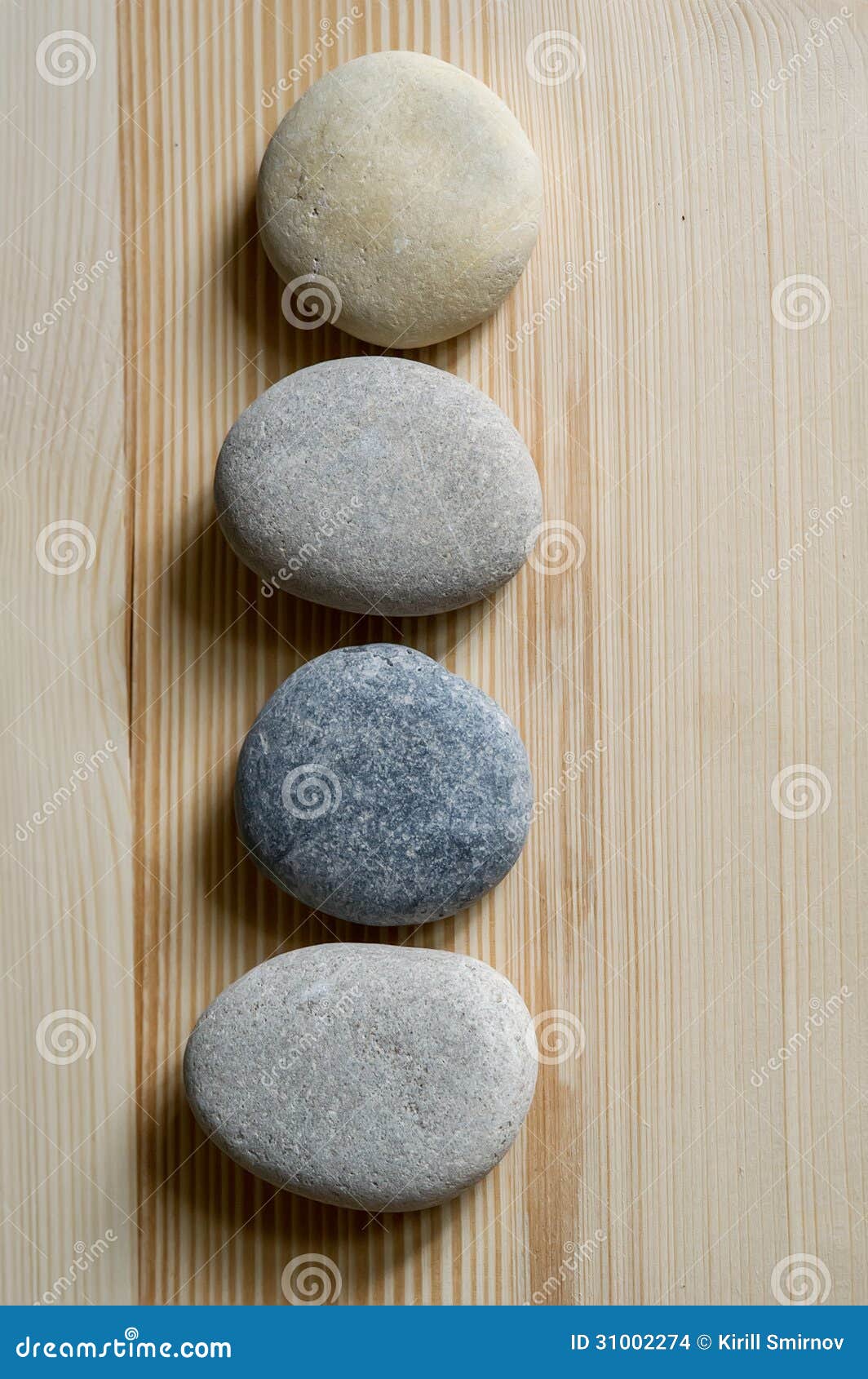Four Stones are Aligned in a Line on Light Wood Background Stock Photo ...