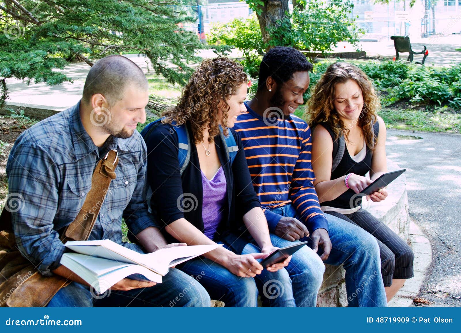 Four Students Comparing Notes Stock Image - Image of outside, adult ...