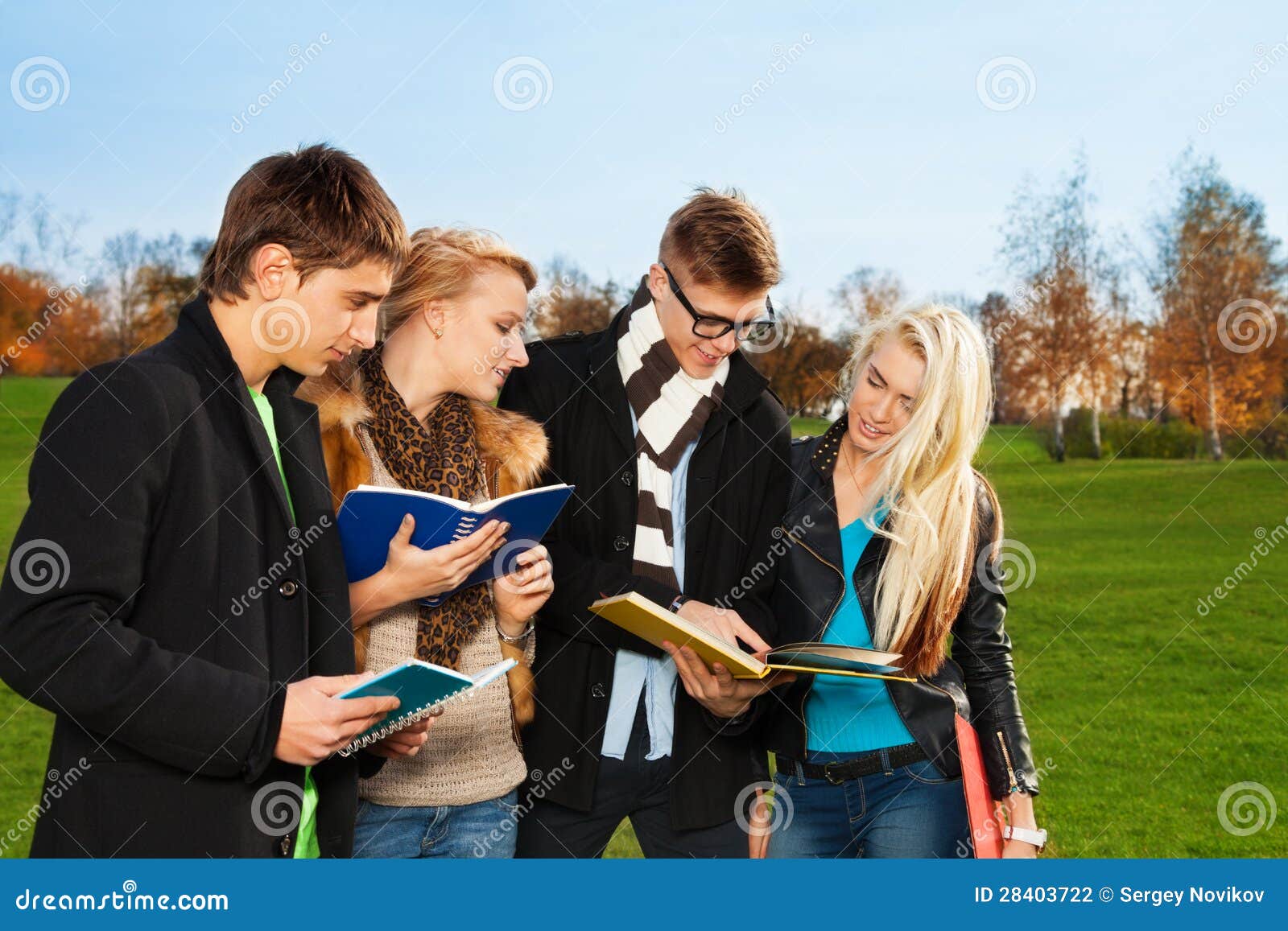 Four Students Discussing Subject in the Park Stock Photo - Image of ...
